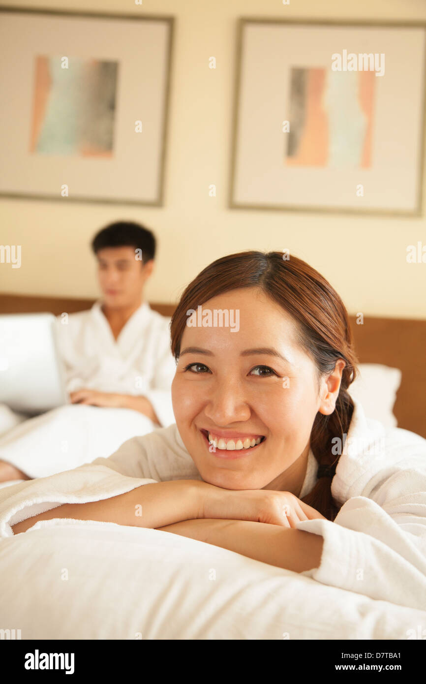 Portrait of Young Girl in Bed with Her Boyfriend in the Background ...