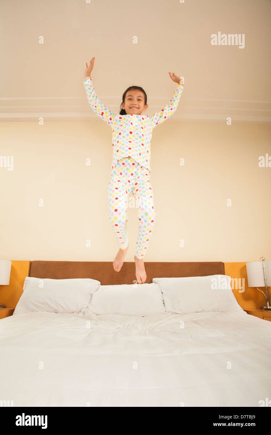 Kid Jumping on Bed Stock Photo - Alamy