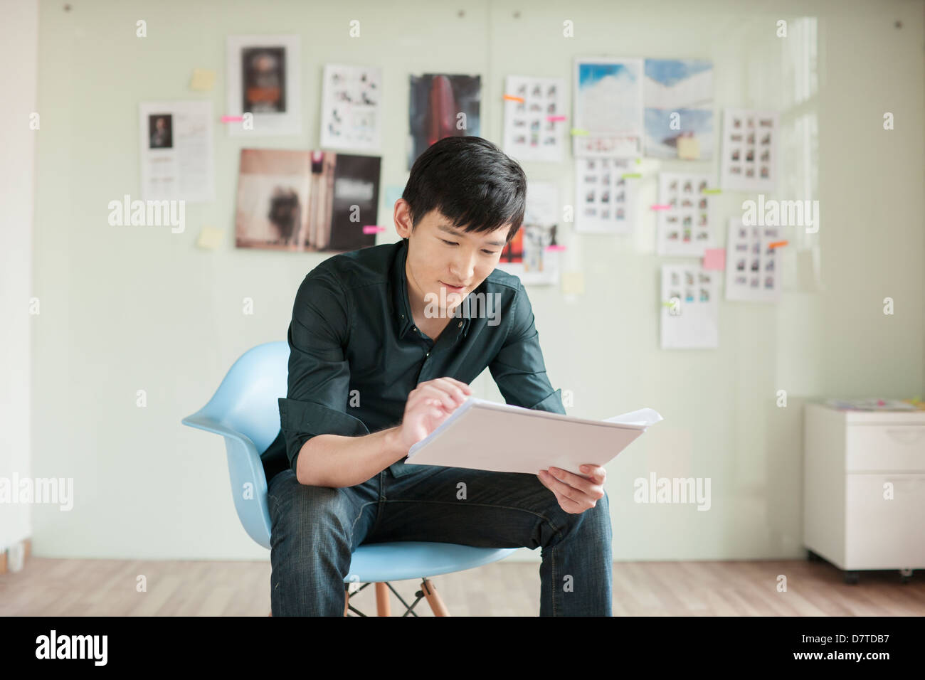 Professional Man Looking at Papers in Office Stock Photo - Alamy