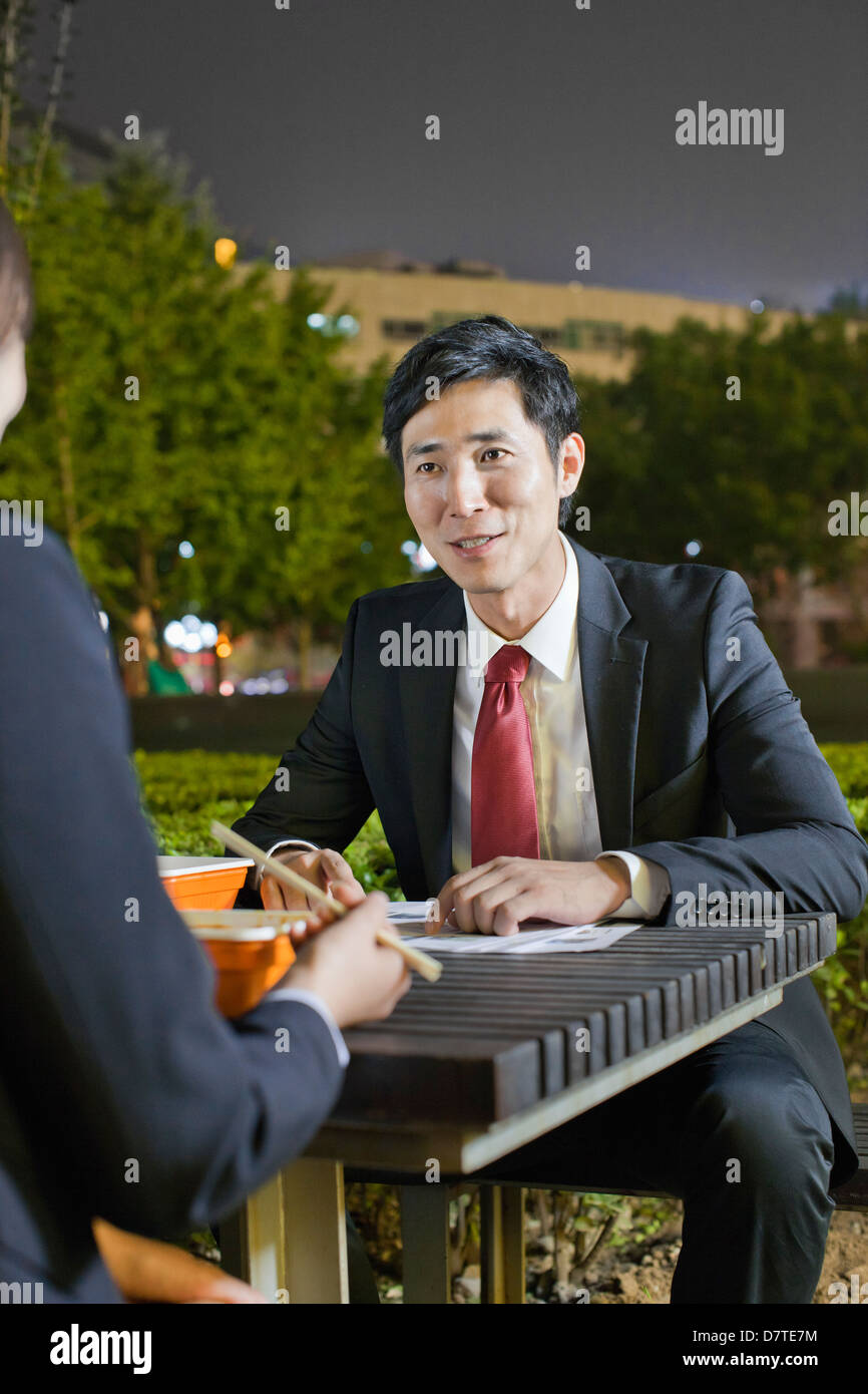 Business People Working While Having Dinner Stock Photo - Alamy