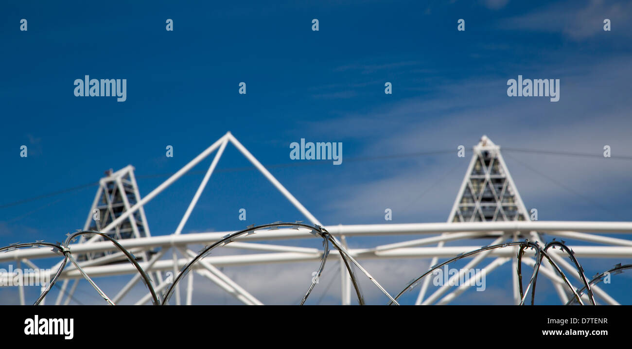 A photograph of the Olympic stadium in London with barbed wire in the ...