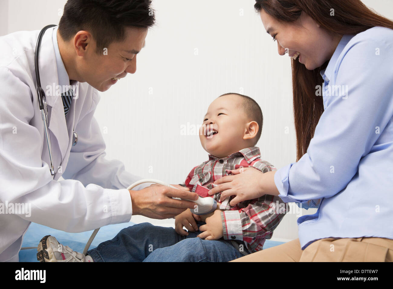 Doctor Examining Baby Boy In Office Stock Photo - Alamy