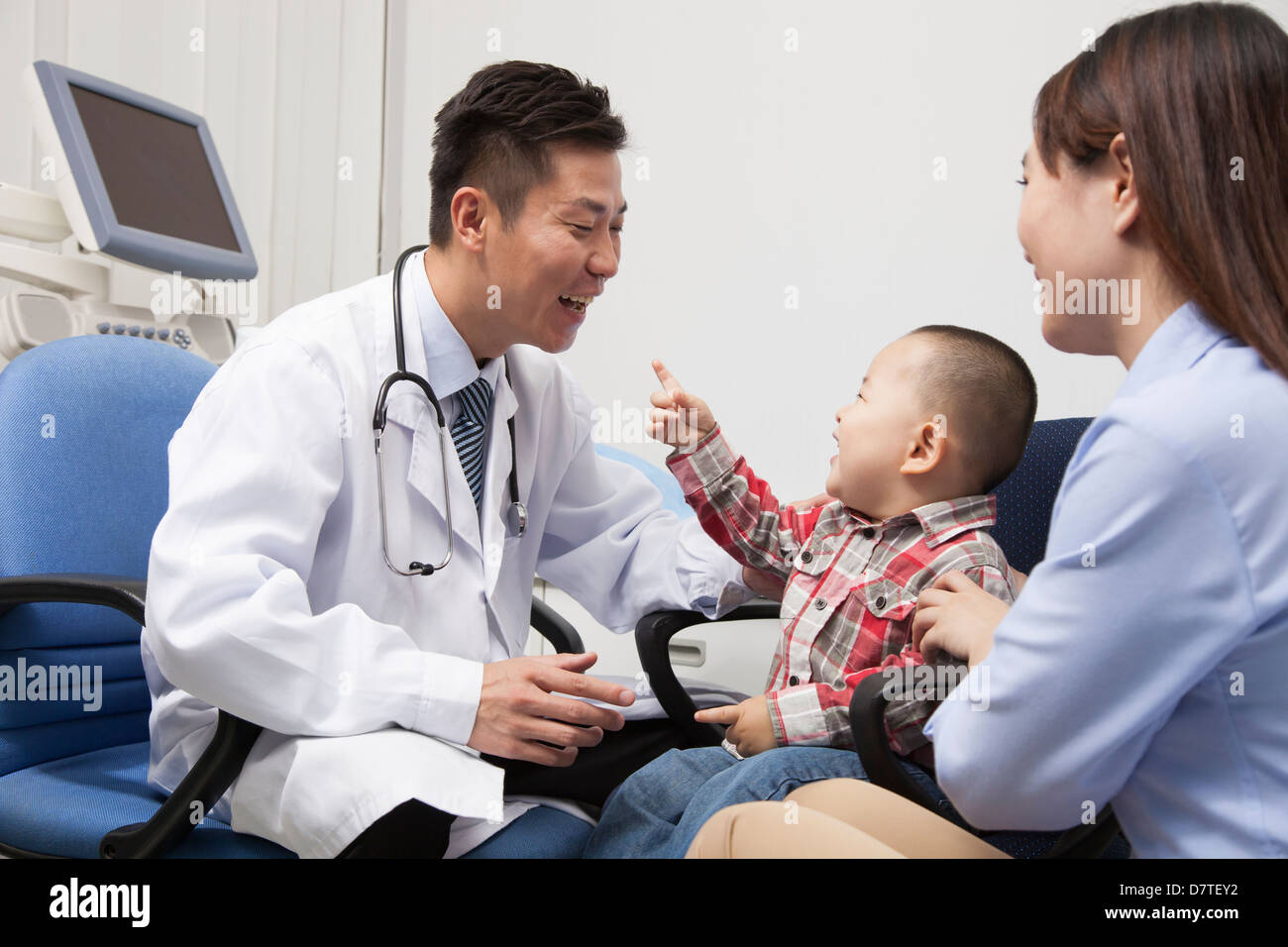 Baby Boy Playing With Doctor In Office Stock Photo - Alamy