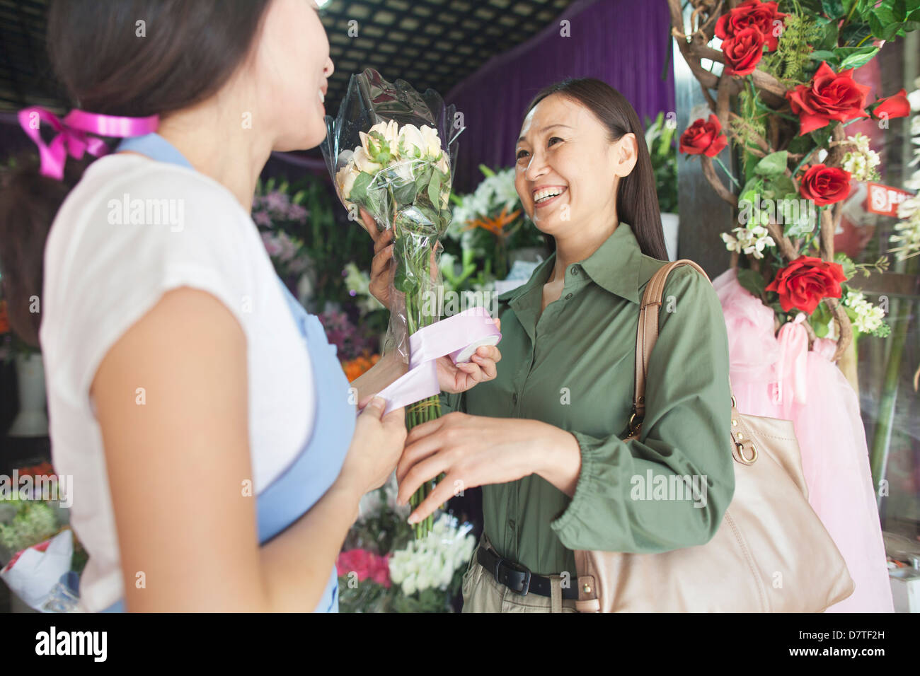 Customer Buying Bunch Of Flowers In Flower Shop Stock Photo - Alamy