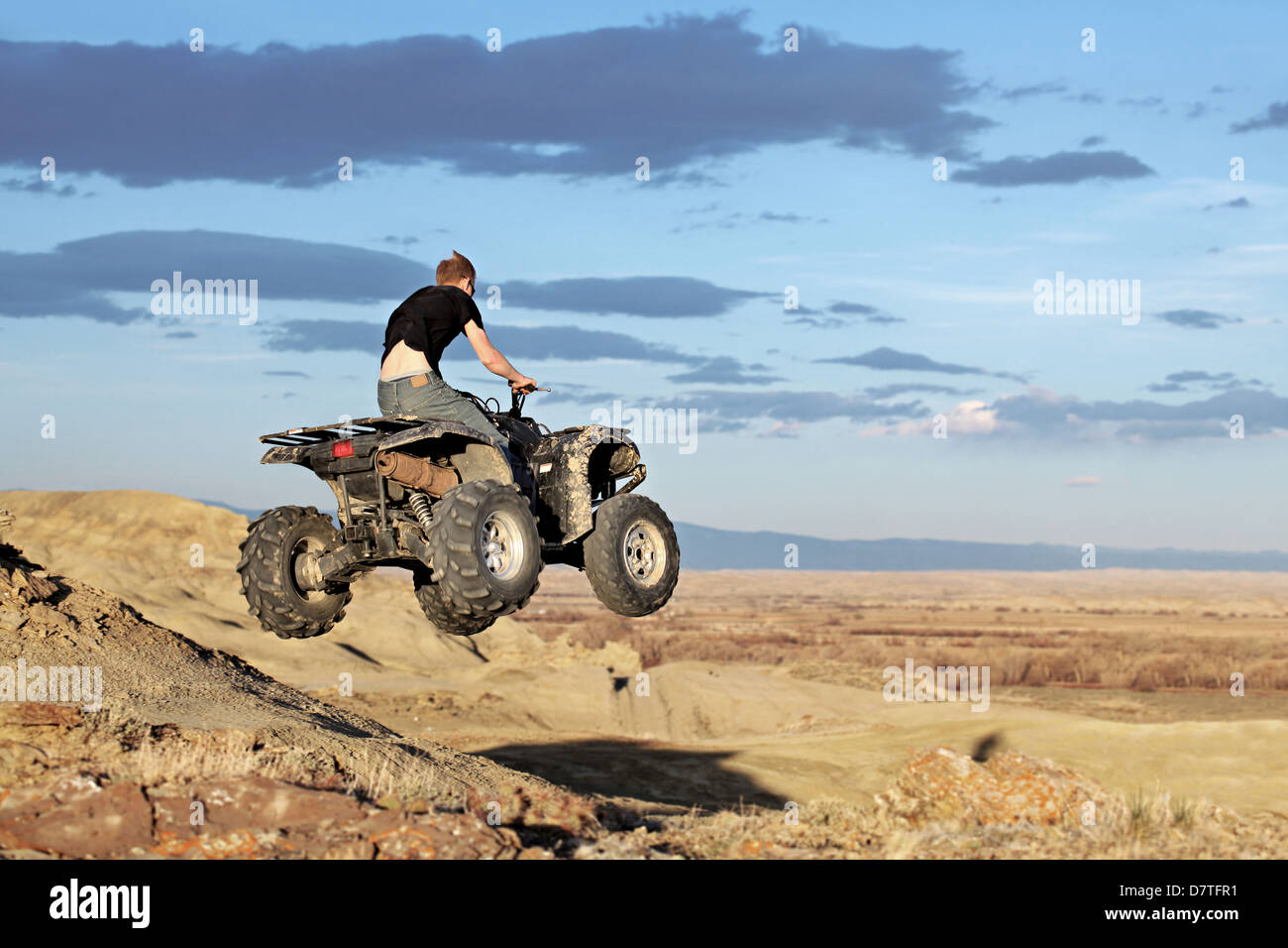 teen jumping on a quad - four wheeler 4x4 gets some air Stock Photo - Alamy