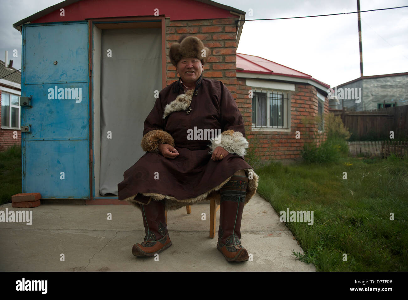mongolian in front of his hand made brick yurt Stock Photo - Alamy