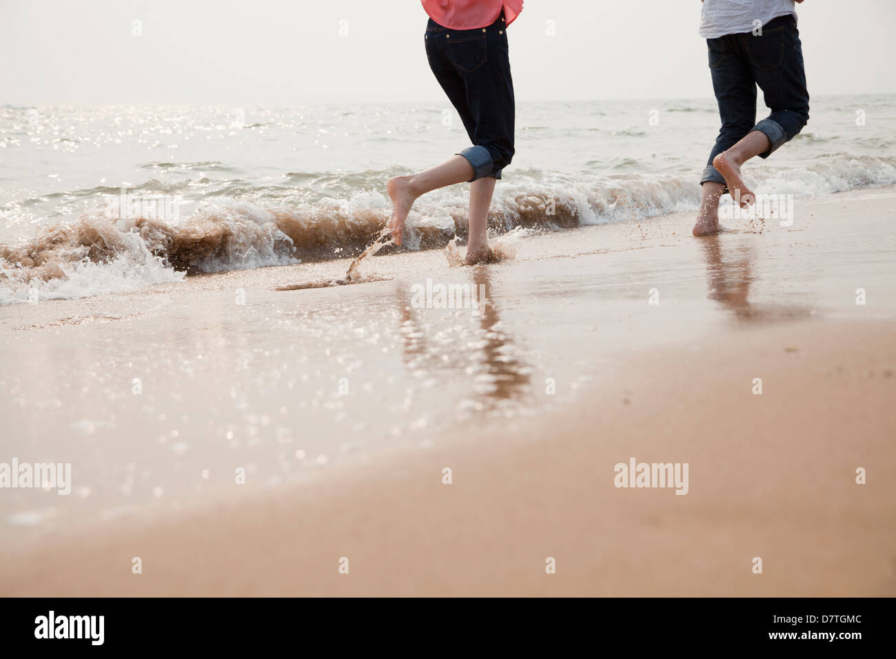 Running in the waves hi-res stock photography and images - Alamy