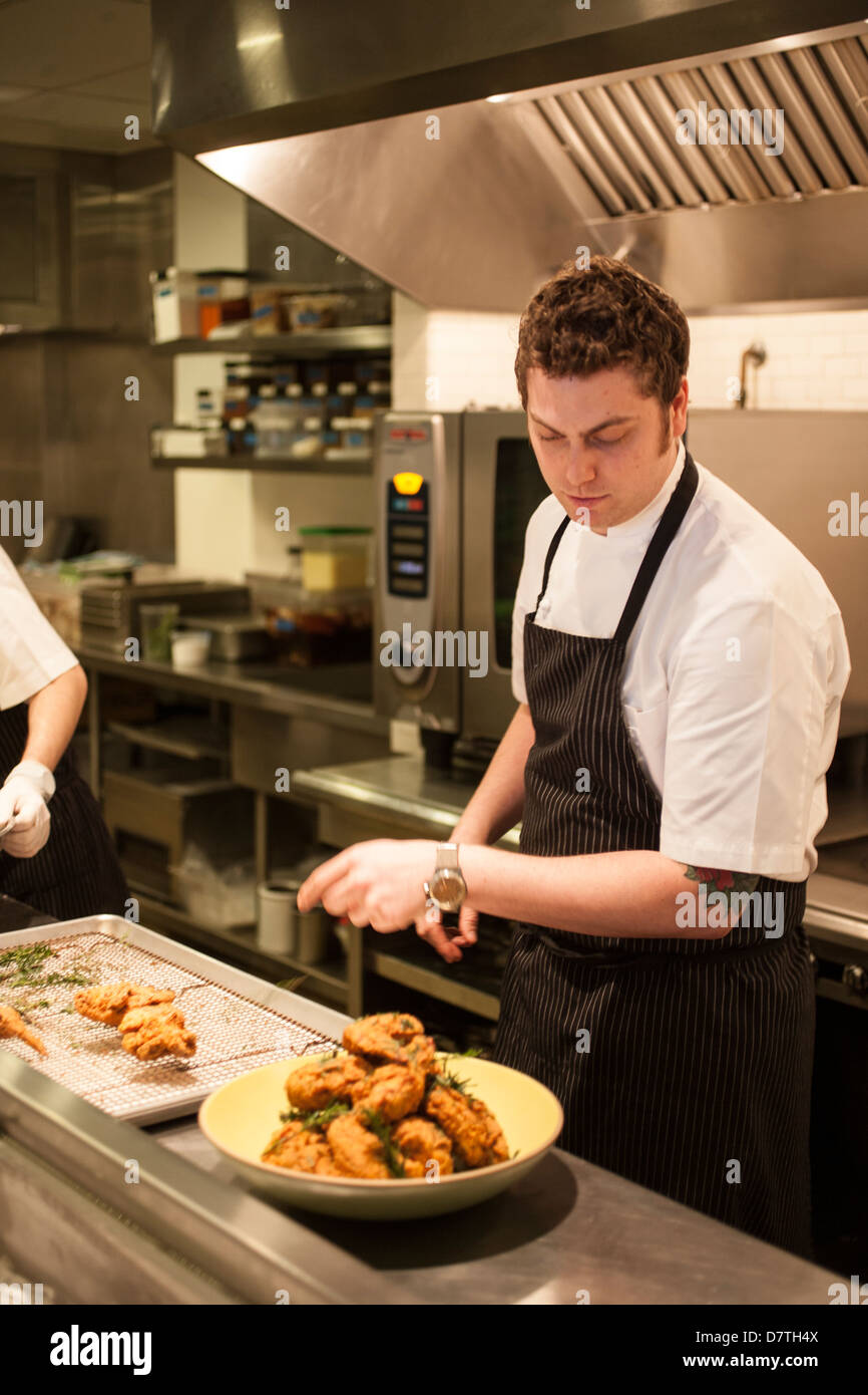 Chef holding bucket of golden fried chicken Stock Photo - Alamy