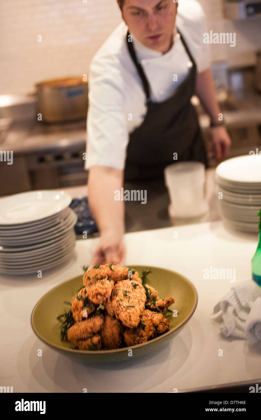 Chef holding bucket of golden fried chicken Stock Photo - Alamy
