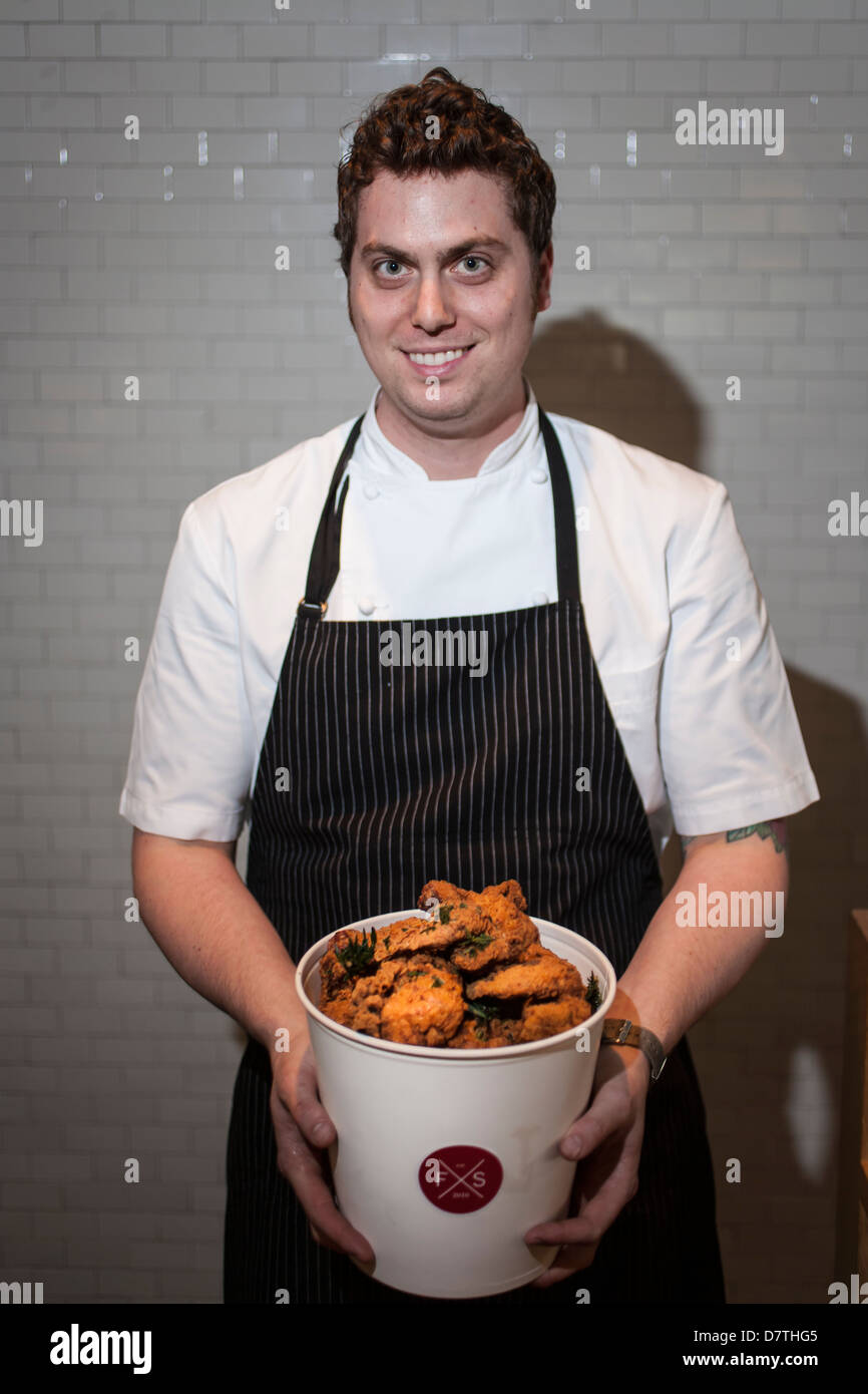 Chef holding bucket of golden fried chicken Stock Photo - Alamy