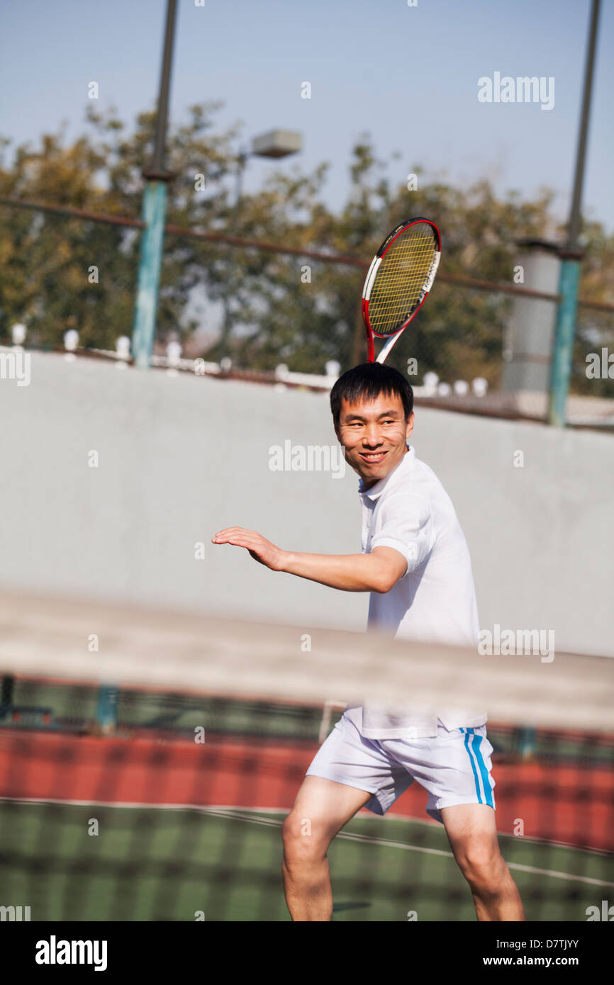 Adult men playing tennis Stock Photo - Alamy