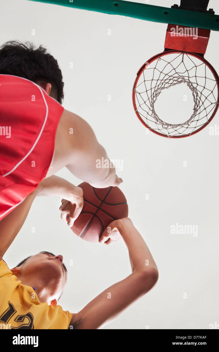 Two people playing basketball, blocking Stock Photo - Alamy