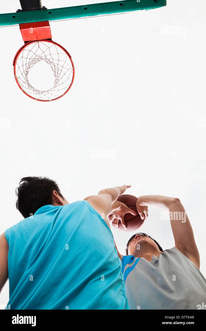 Two people playing basketball, blocking Stock Photo - Alamy