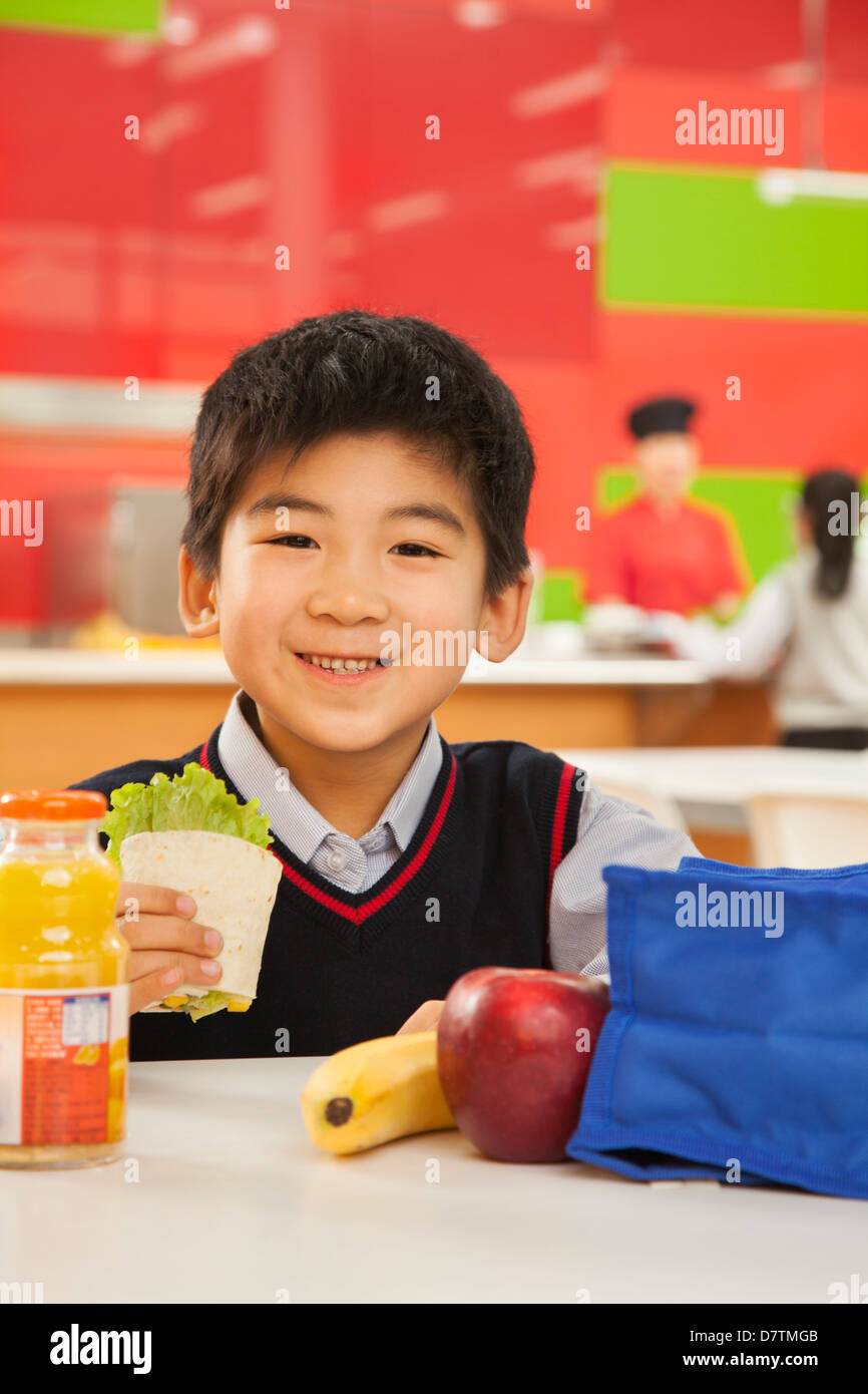 School boy portrait eating lunch in school cafeteria Stock Photo - Alamy