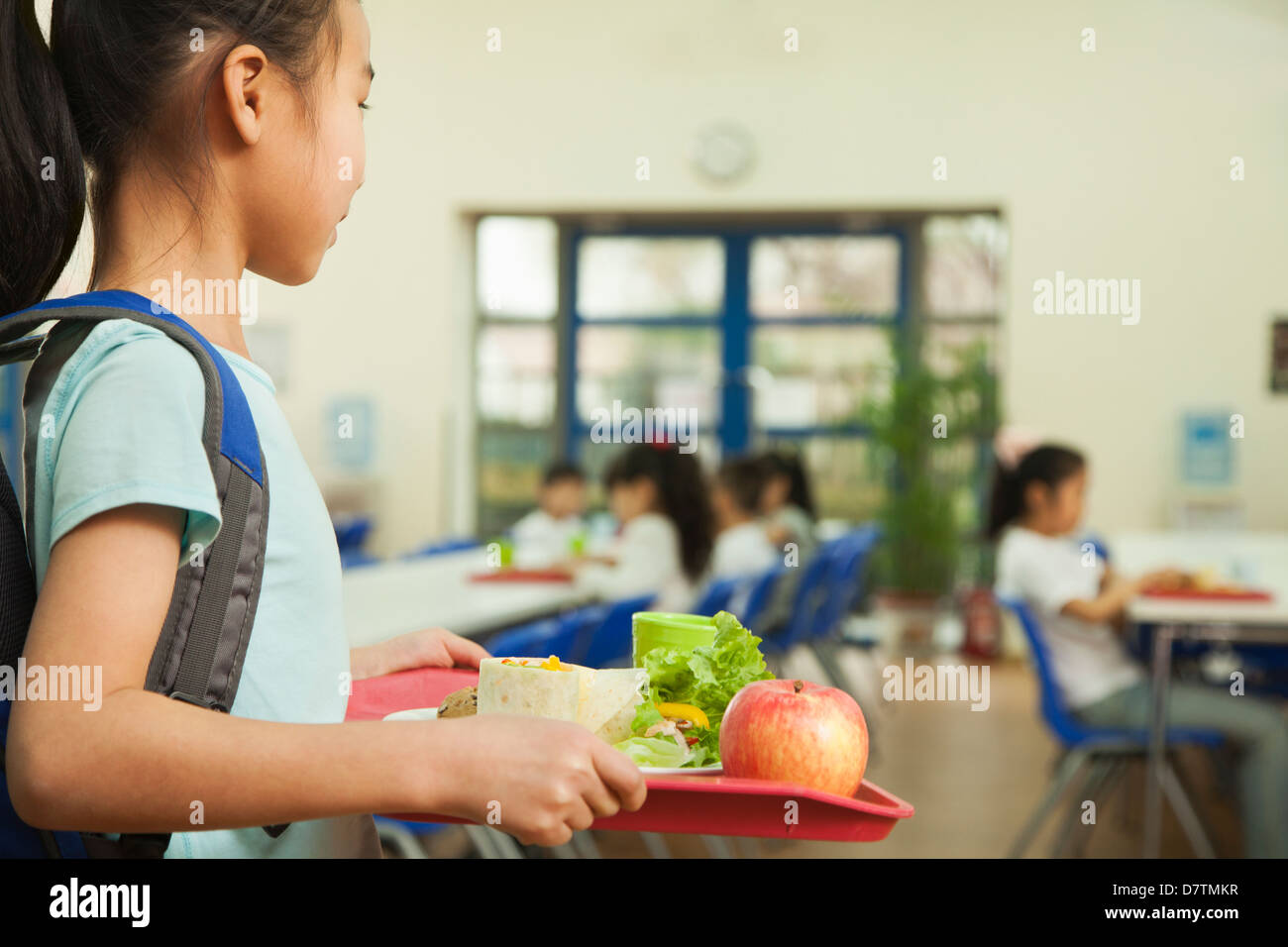 School girl holding food tray in school cafeteria Stock Photo - Alamy
