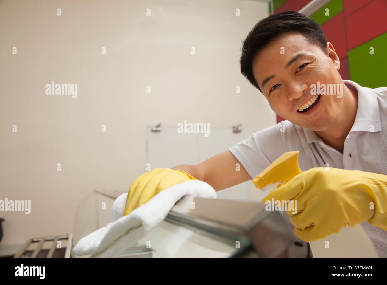 Cafeteria worker cleaning food serving area Stock Photo - Alamy