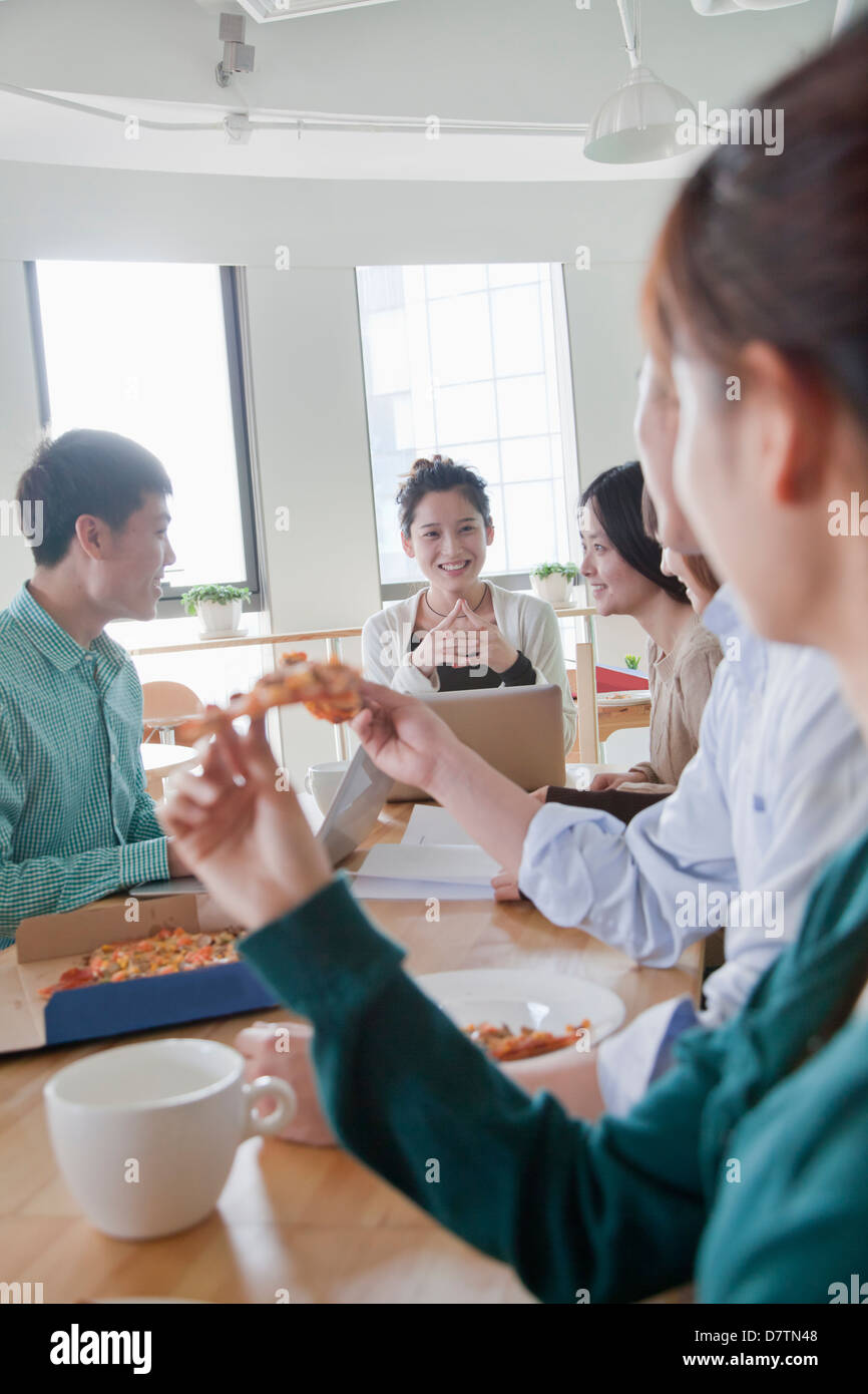 Coworkers eating and working in the cafeteria Stock Photo - Alamy