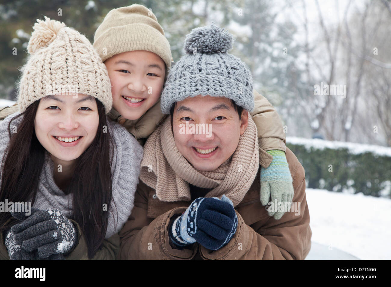 Family laying in snow for portrait Stock Photo - Alamy