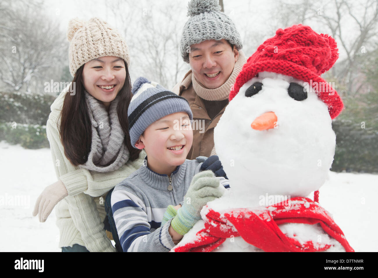Two boys making a snowman hi-res stock photography and images - Alamy