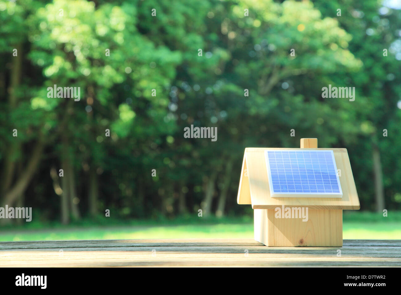 Miniature wooden house with solar panels Stock Photo - Alamy