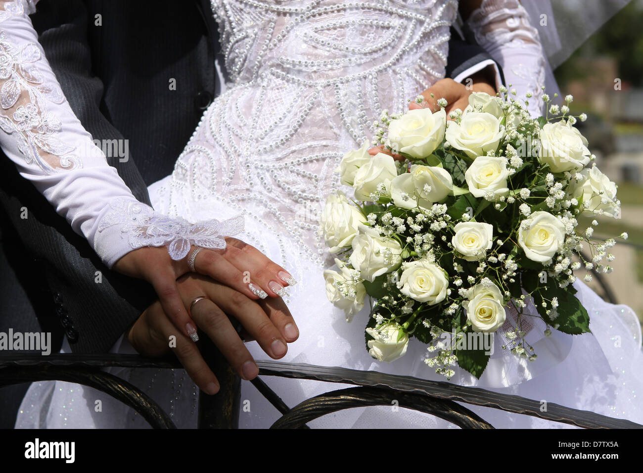 Hands of bride and groom in a heart shape on wedding bouquet Stock ...