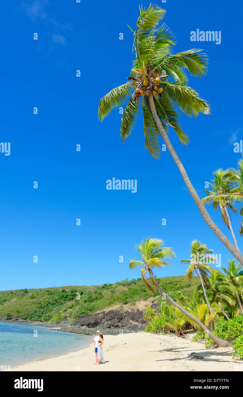 Couple on a tropical beach, Drawaqa Island, Yasawa island group, Fiji ...