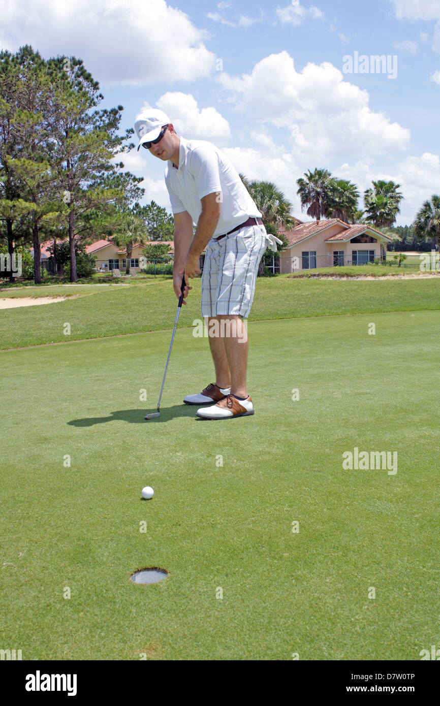 Young man on the golf course Stock Photo - Alamy