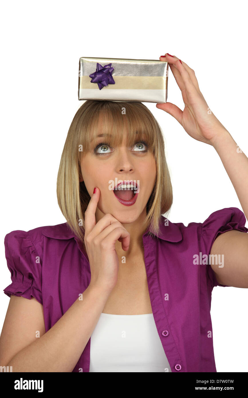 Excited woman holding mystery gift Stock Photo - Alamy
