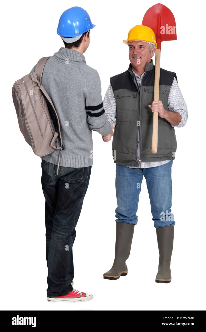 A construction worker and his apprentice Stock Photo - Alamy