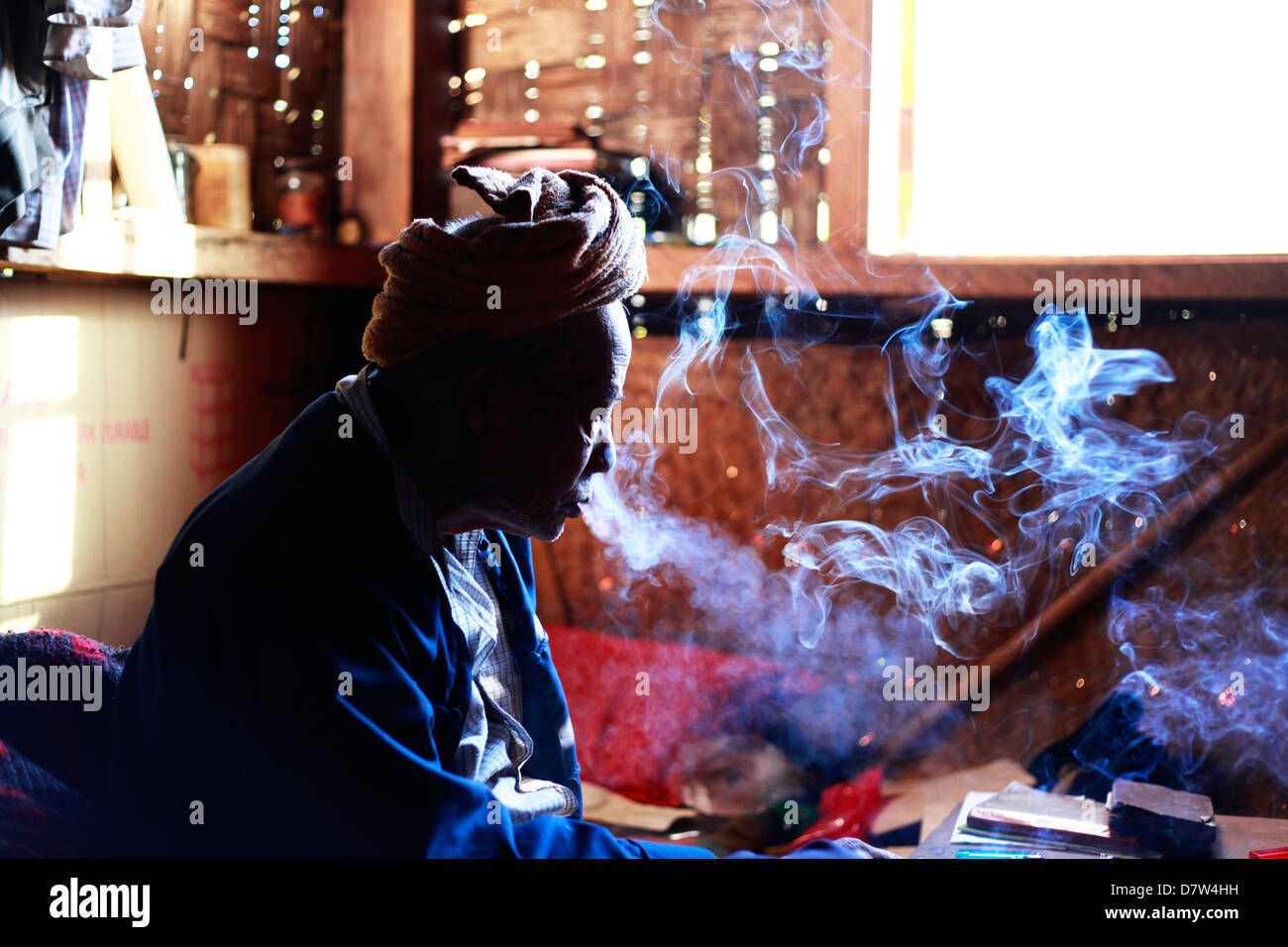 The last shaman of the Pa-O tribe, Myanamar, smokes his cigar in his ...