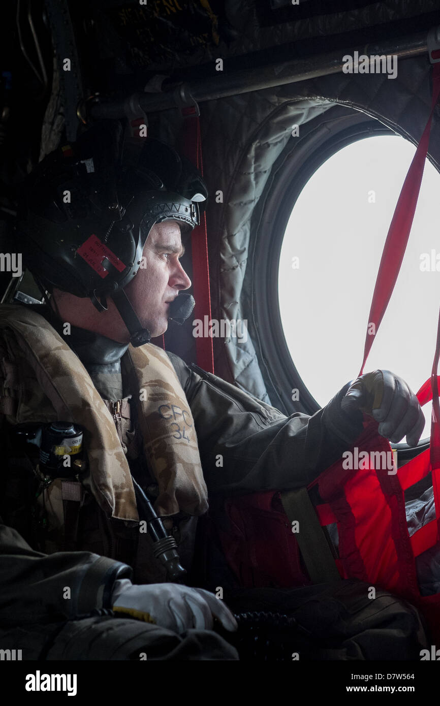 An RAF Aircrewman by the window while flying in an RAF Chinook Mk2 ...