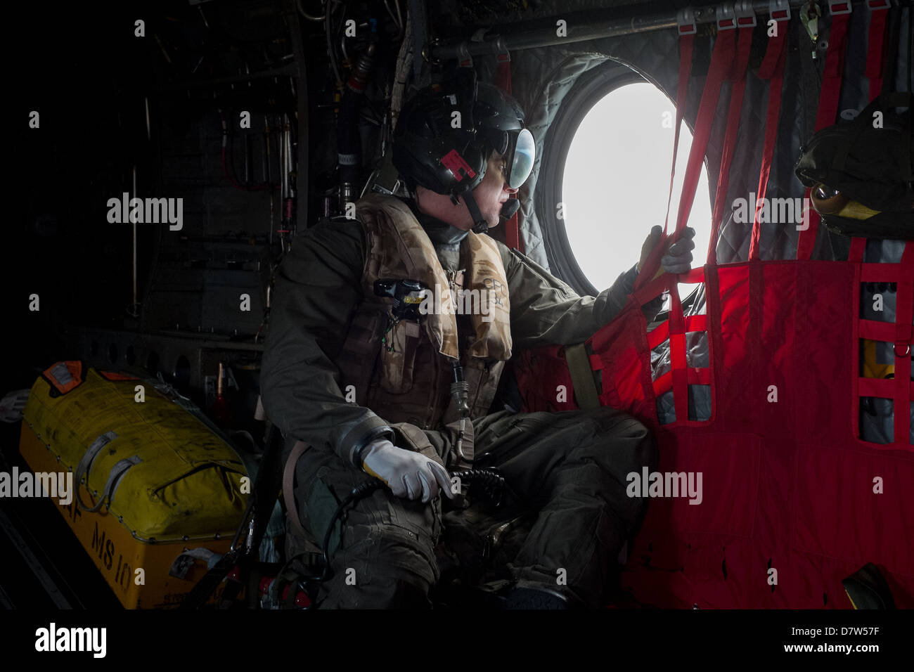 An RAF Aircrewman by the window while flying in an RAF Chinook Mk2 ...