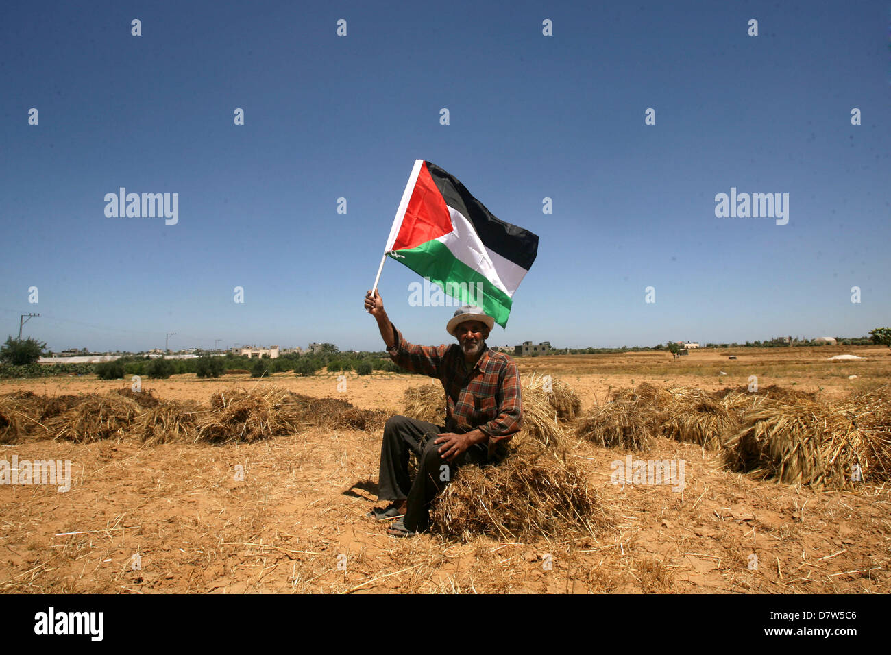May 14, 2013 - Rafah, Gaza Strip - A man holds a Palestinian flag ...