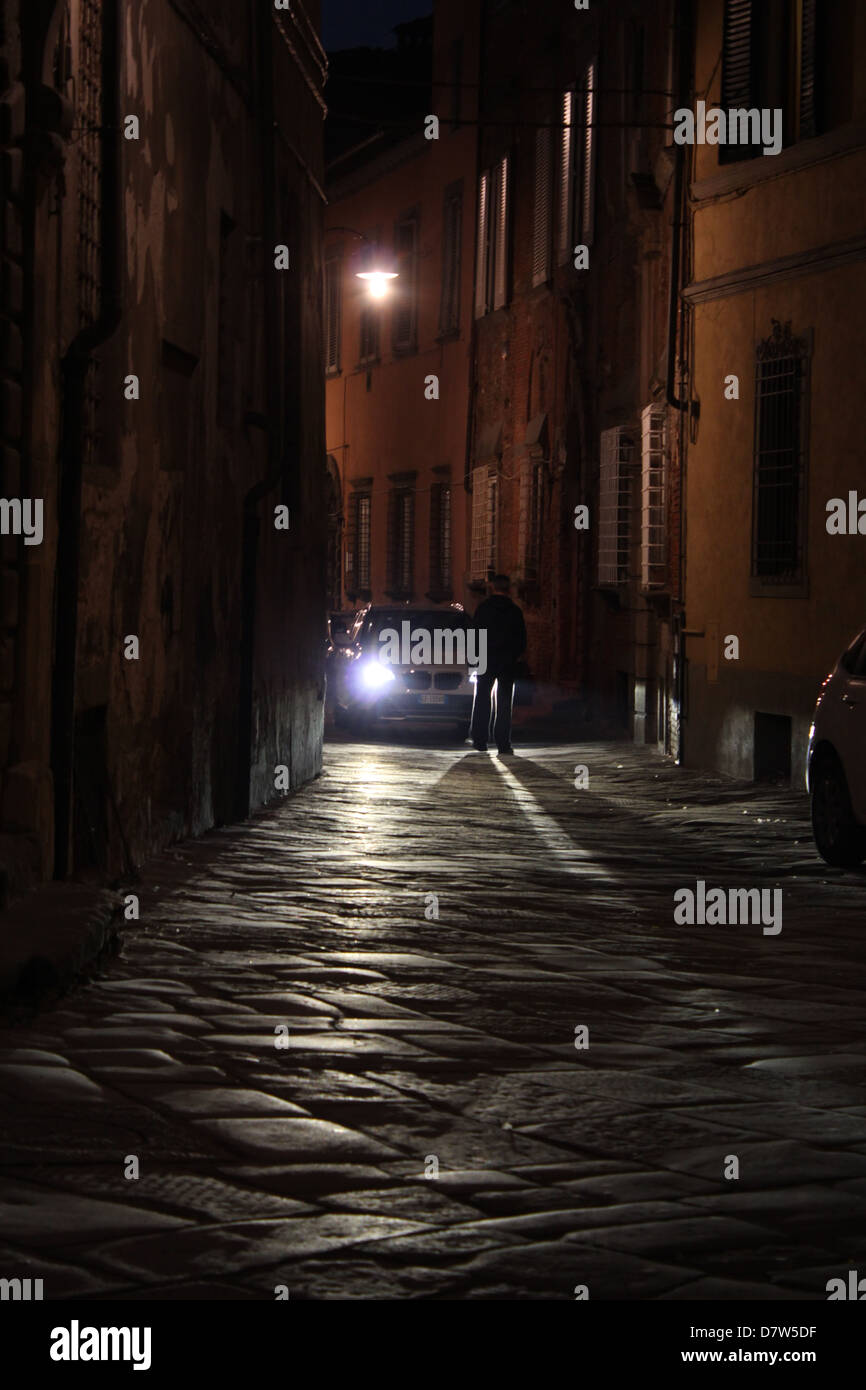 car in dark alley in street road in lucca tuscany italy Stock Photo - Alamy