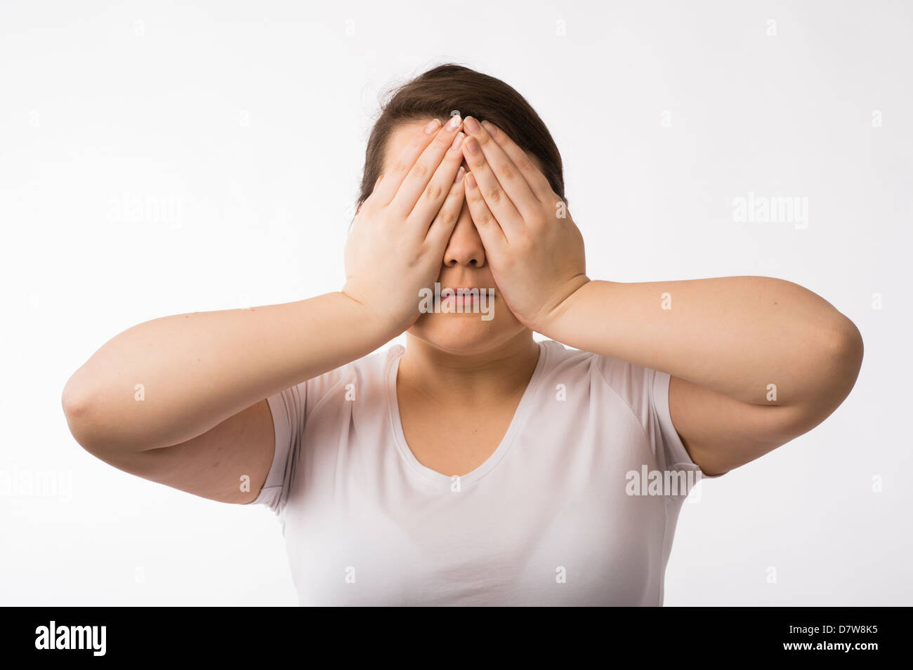 See No Evil: A young brunette teenage Caucasian girl with her hands ...