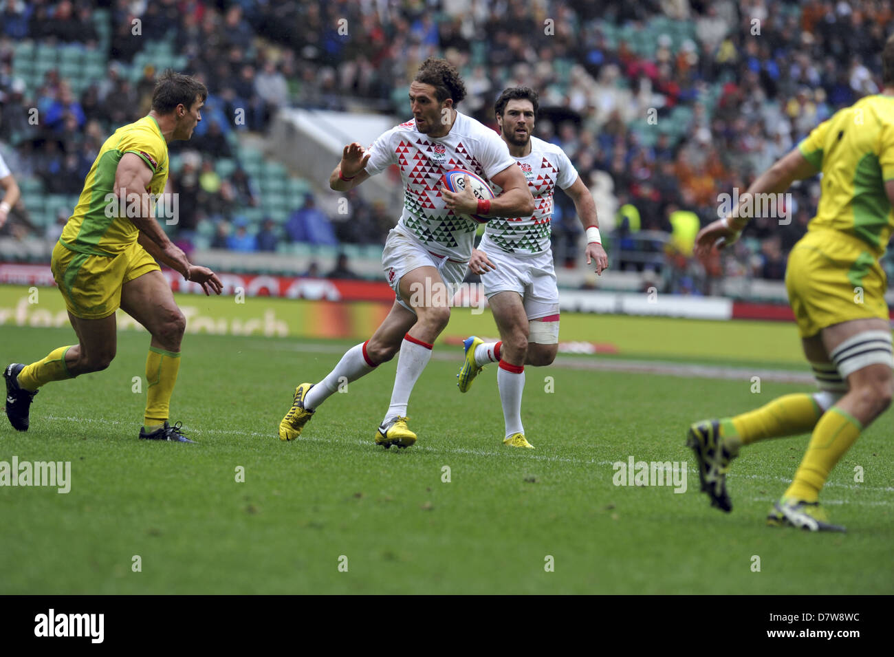 Mike Ellery (Forward, England) fending off a tackle from an Australian ...