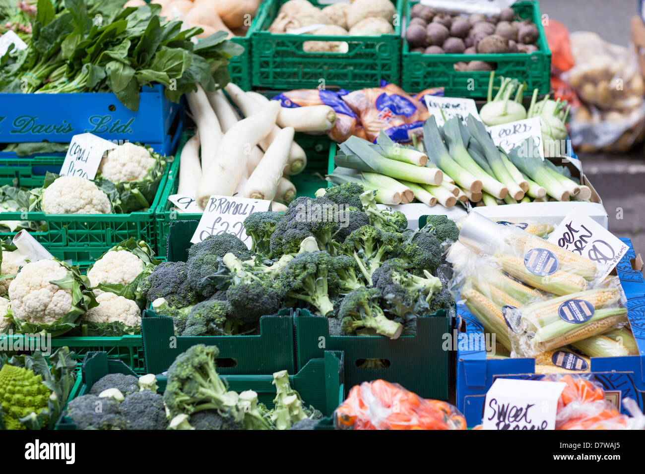 Broccoli and other vegetables on display for sale on a market stall ...