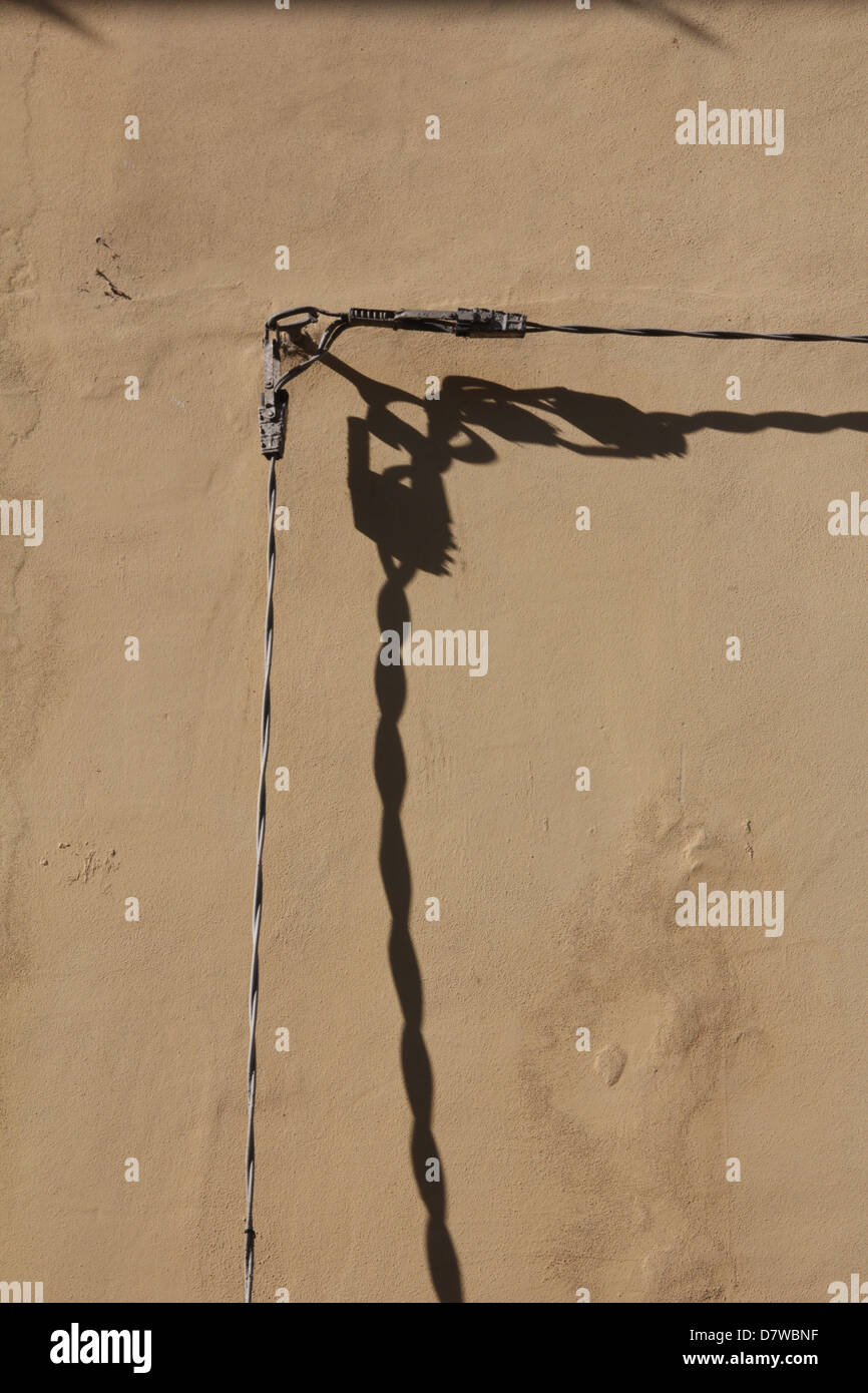 tight wire rope on brown wall in , italy shadow angle corner square sun ...