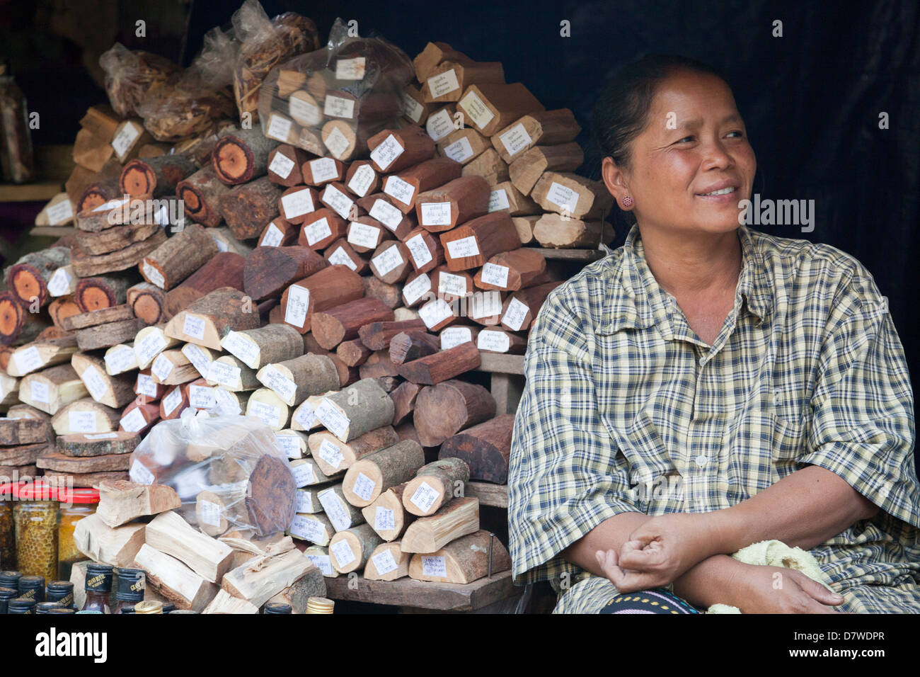 Woman selling Thanaka bark outside Peik Khyin Myaung Caves, Myanmar ...