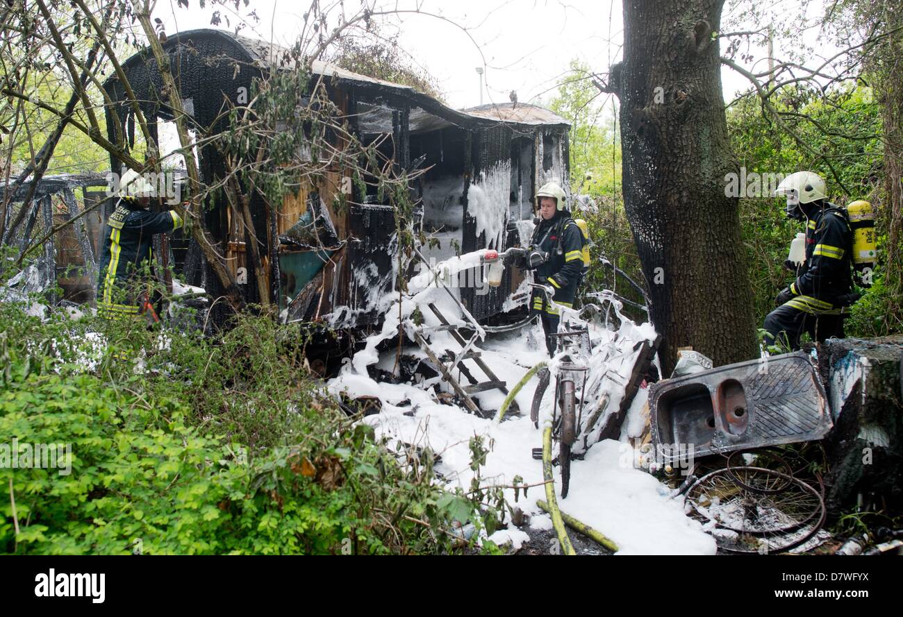 Firemen extinguish the fire in a burning caravan in Hanover, Germany ...