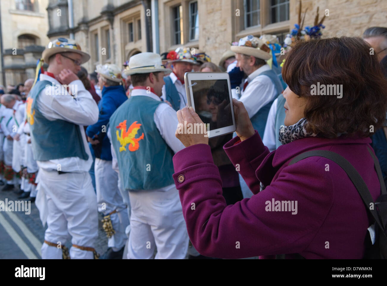 May day morning tourist taking photograph of Morris dancers using their ...