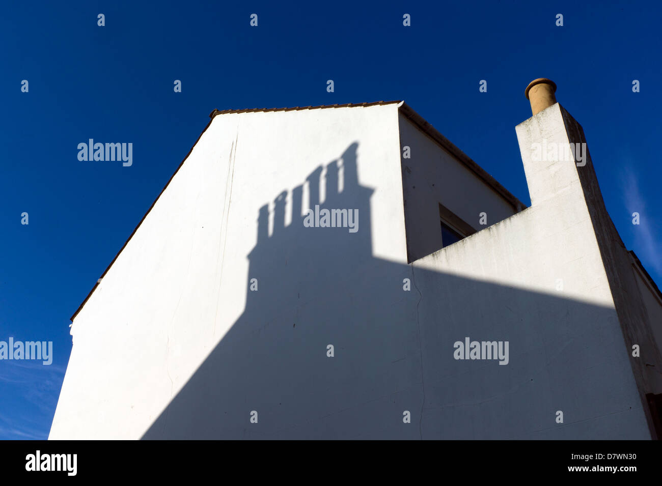 Shadow of chimneys on side wall of house, blue sky Stock Photo - Alamy