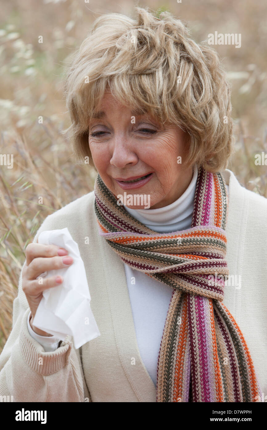 Elderly woman suffering from hay fever Stock Photo - Alamy