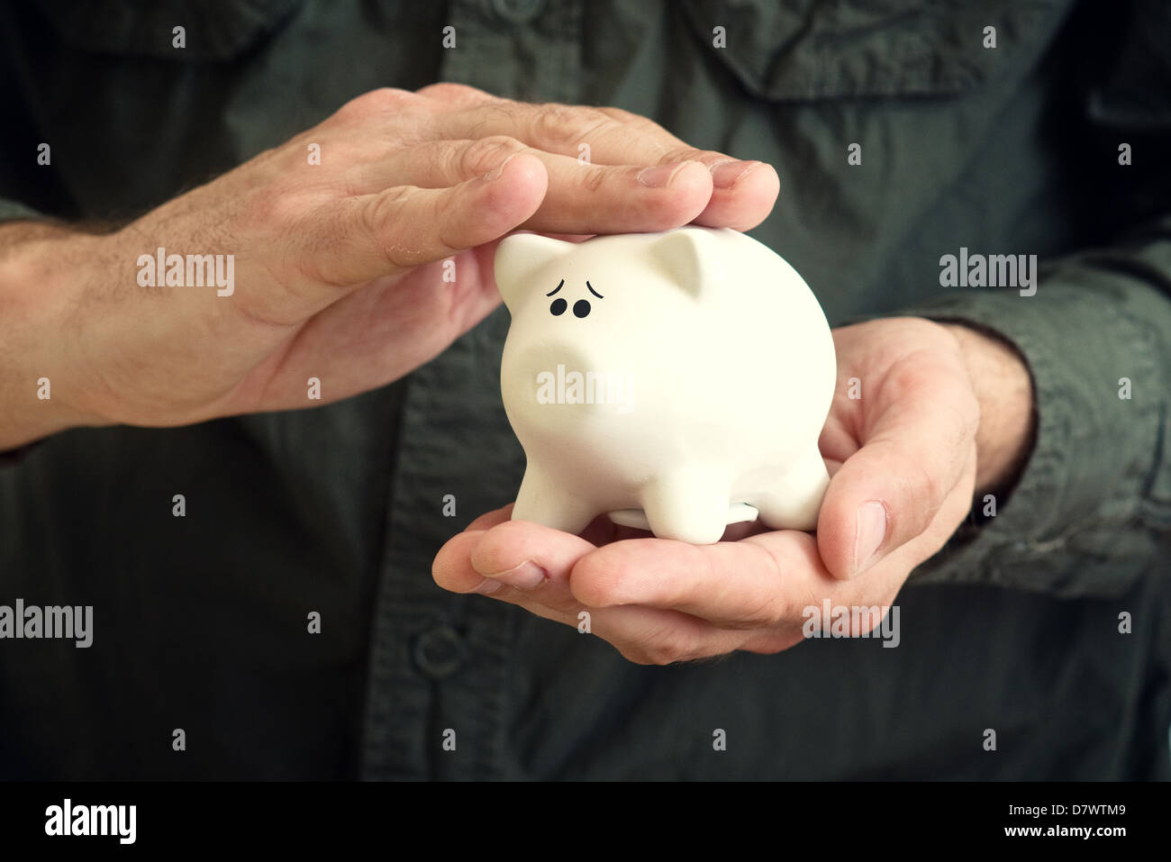 Hand cuddles white piggy coin bank with scared look in its eyes Stock ...