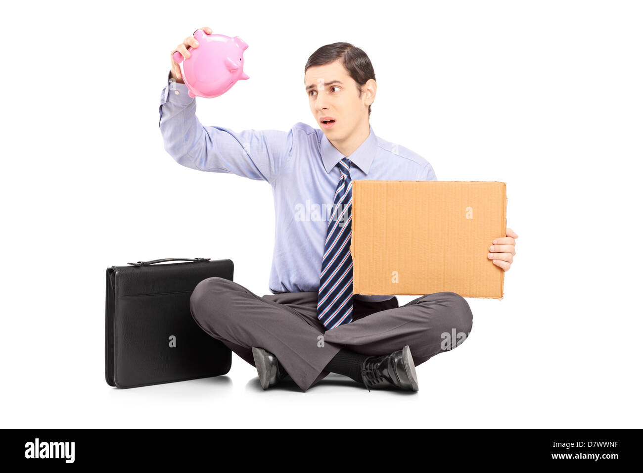 Poor businessman holding an empty money box and a piece of cardboard ...