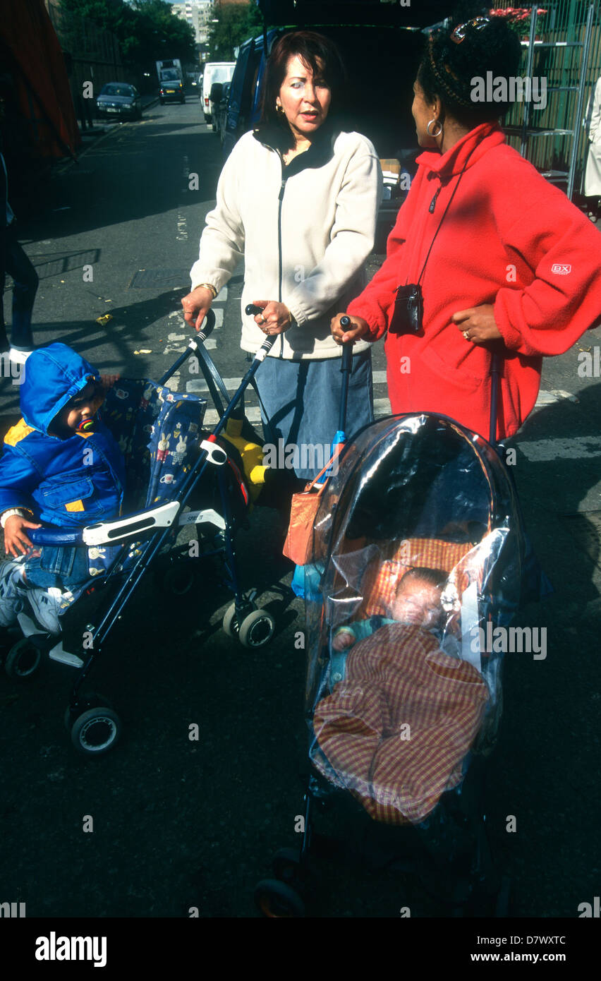 Mothers with their babies chatting in the street, Southwark, south ...