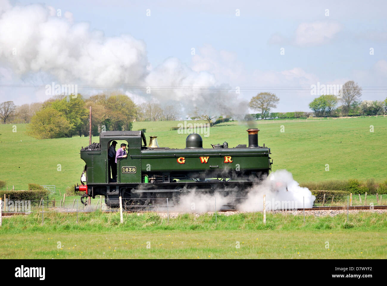 A steam train makes its way along through the Kent Countryside on a ...