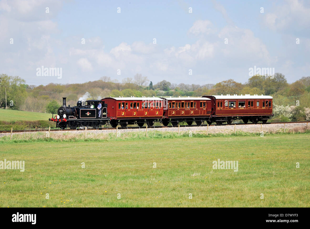 A steam train makes its way along through the Kent Countryside on a ...