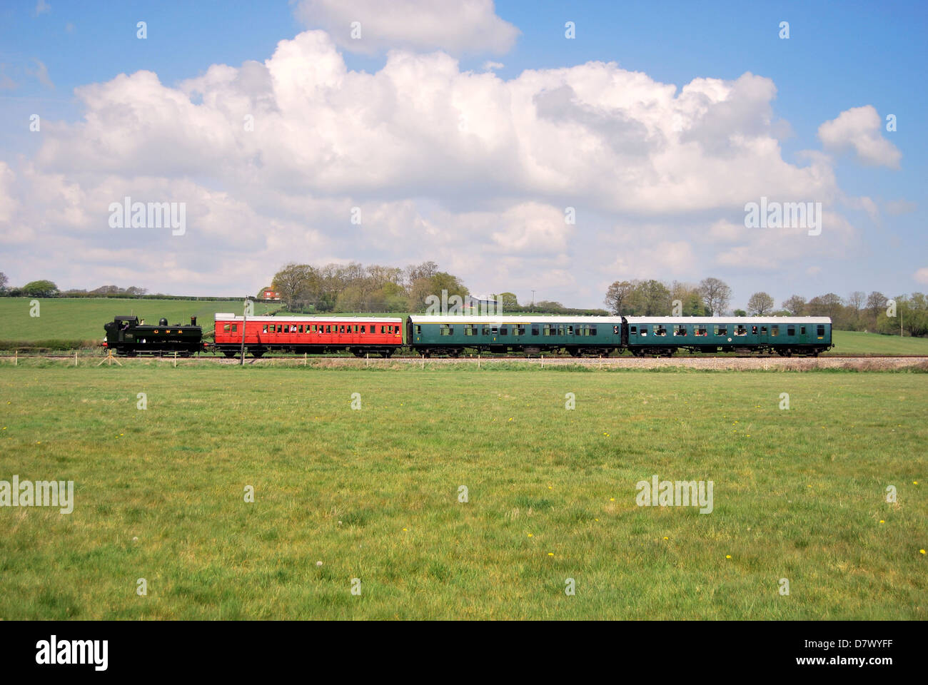 A steam train makes its way along through the Kent Countryside on a ...