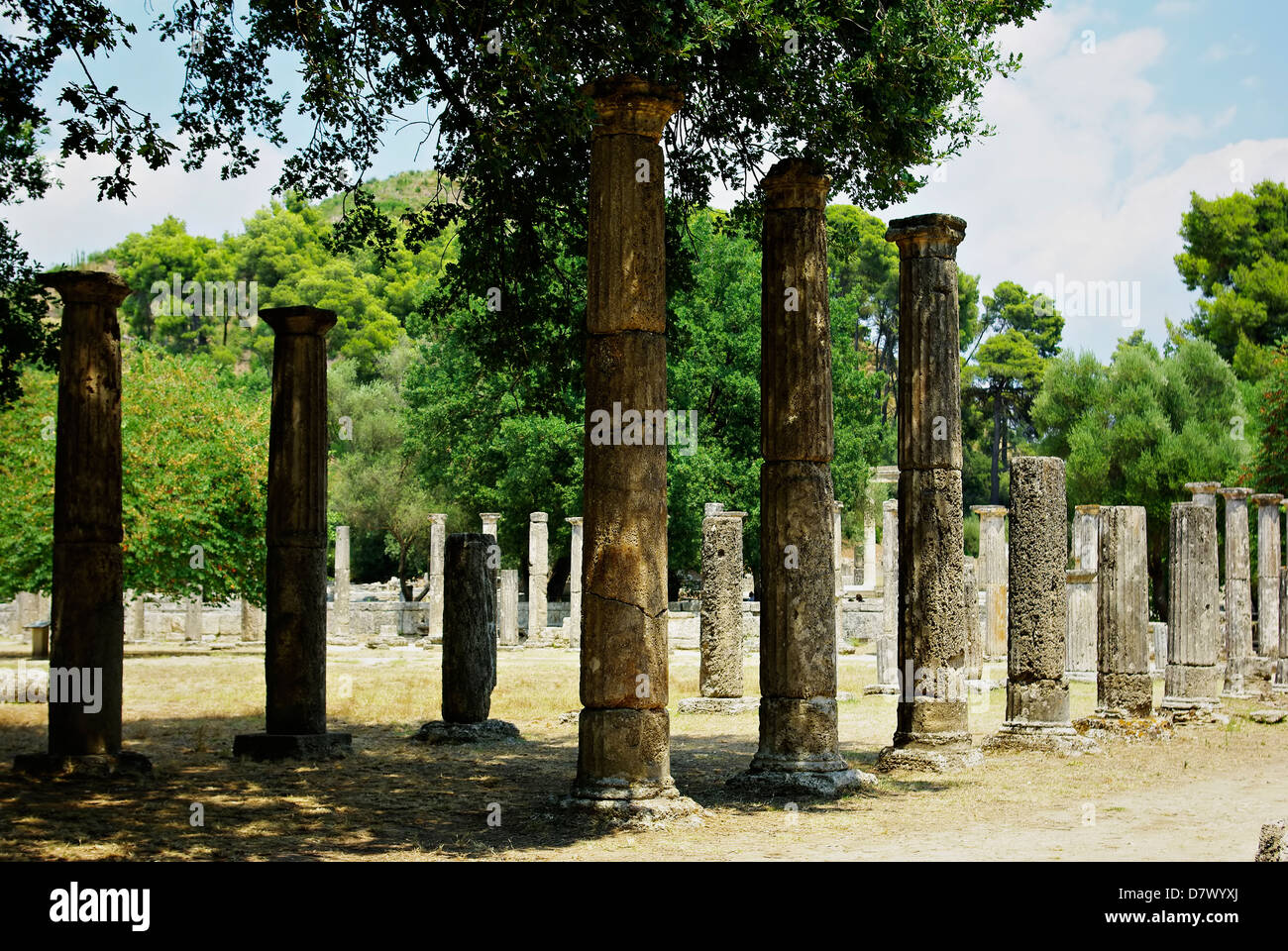 Old stone columns in open museum at Olympia, Greece at sunny summer day ...